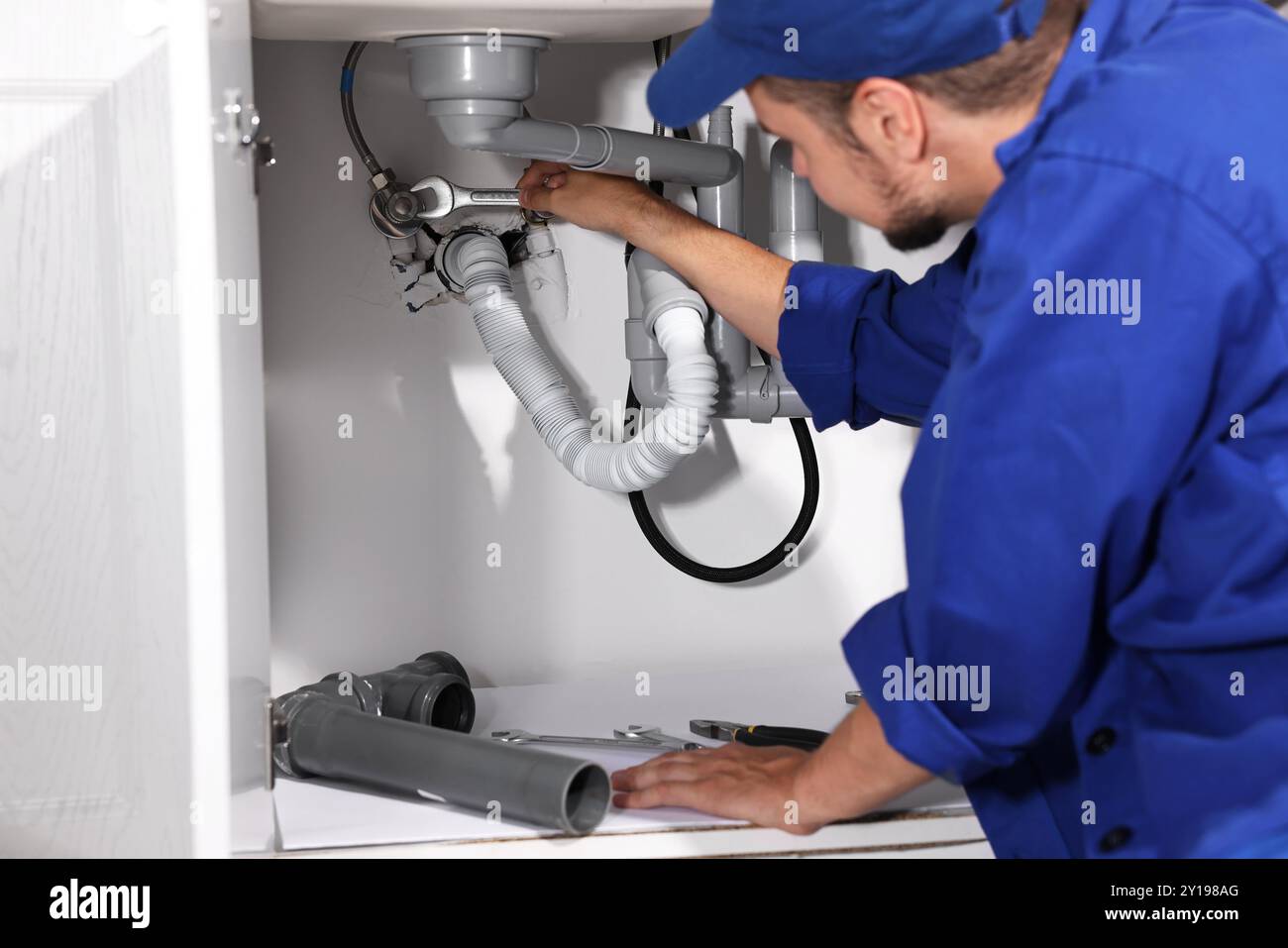 Professional plumber fixing piping system at home Stock Photo - Alamy