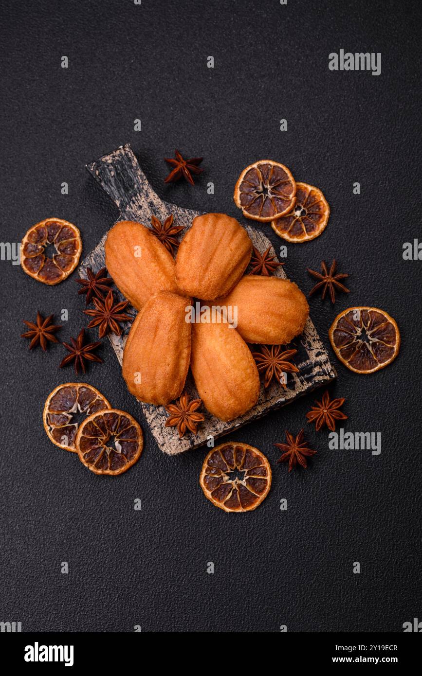 Traditional French madeleine biscuits with nutty flavor on a dark ...