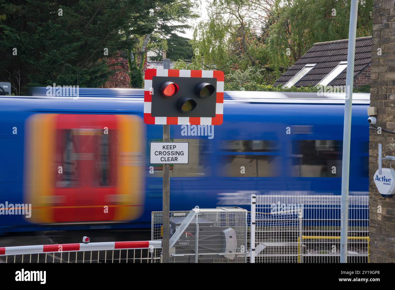 Train pass level crossing UK Stock Photo - Alamy