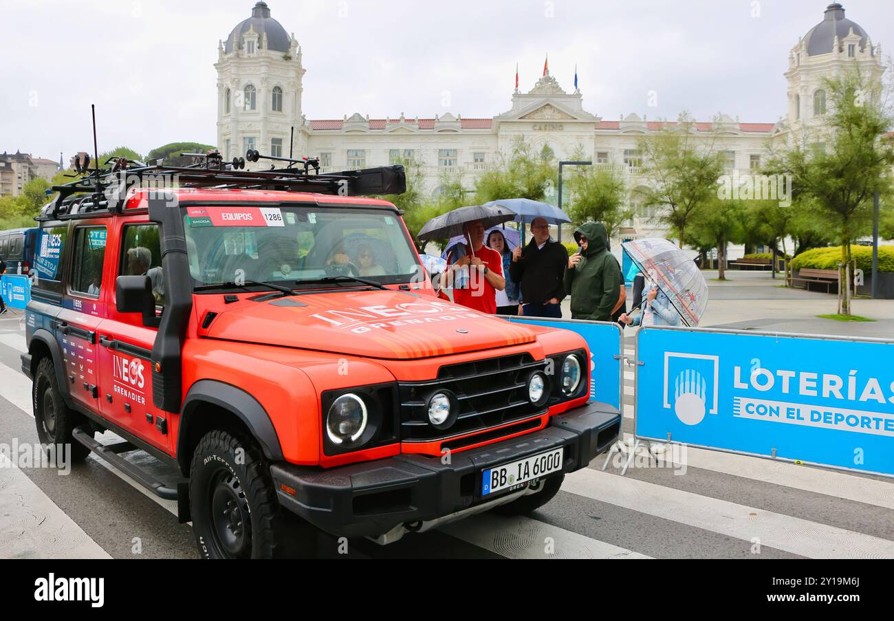 INEOS Grenadiers team support car passing the Plaza Italia in pouring ...