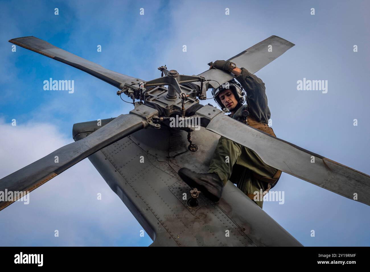 Naval Aircrewman (Helicopter) 3rd Class conducts pre-flight checks on ...