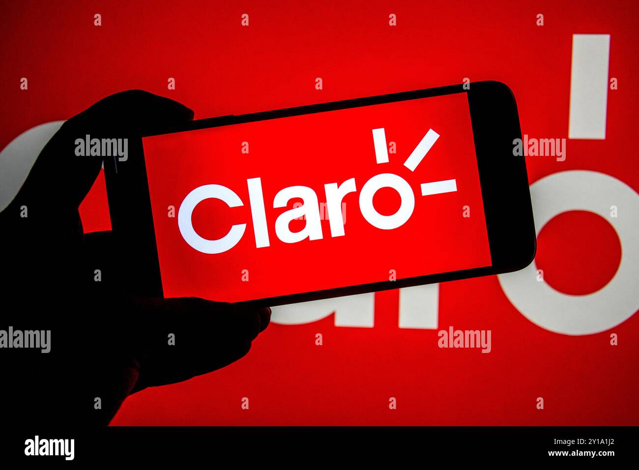 In this photo illustration, a Claro logo seen displayed on a smartphone ...