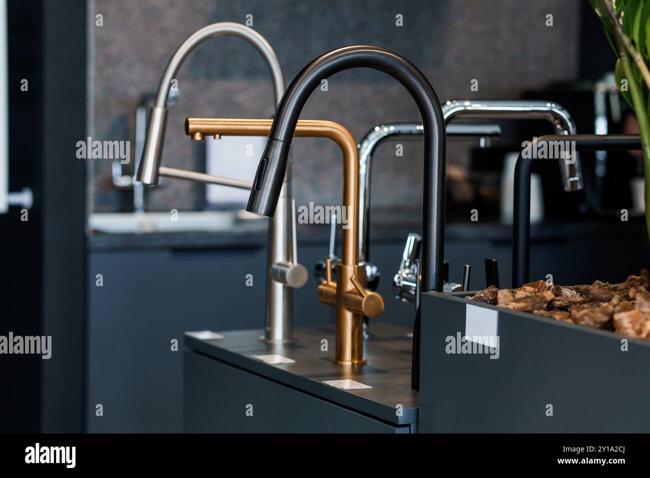 Modern Kitchen Taps Display in a Sleek Showroom Setting Stock Photo - Alamy