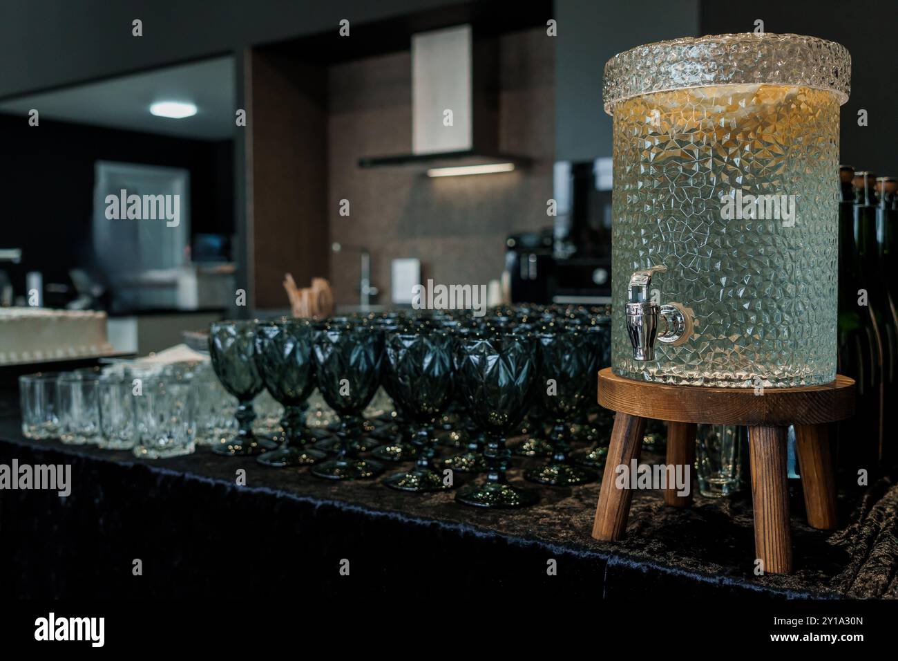 Elegant Beverage Display with Vintage Glassware and Textured Dispenser ...