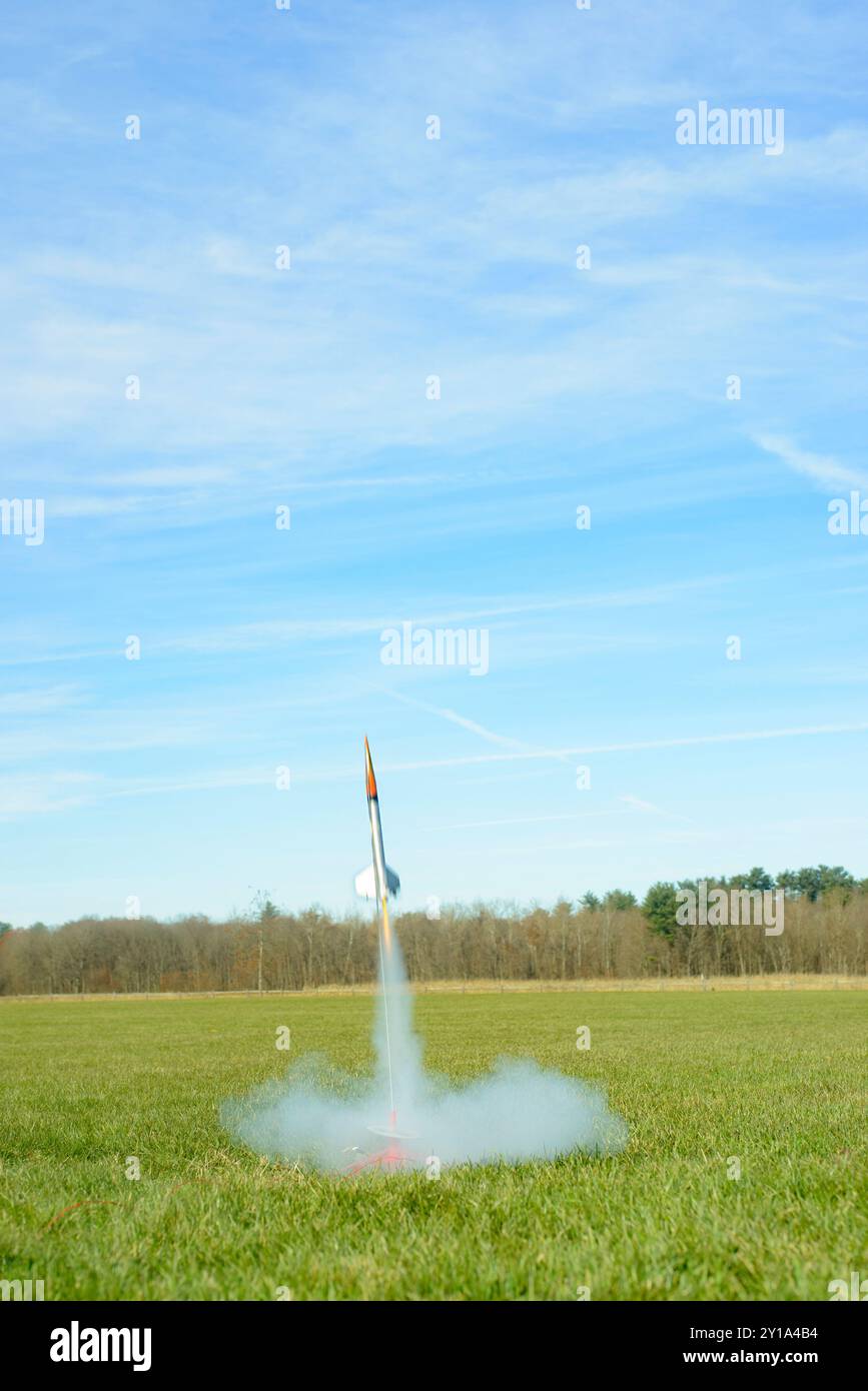 Toy rocket taking off from taking off from grassy field Stock Photo - Alamy