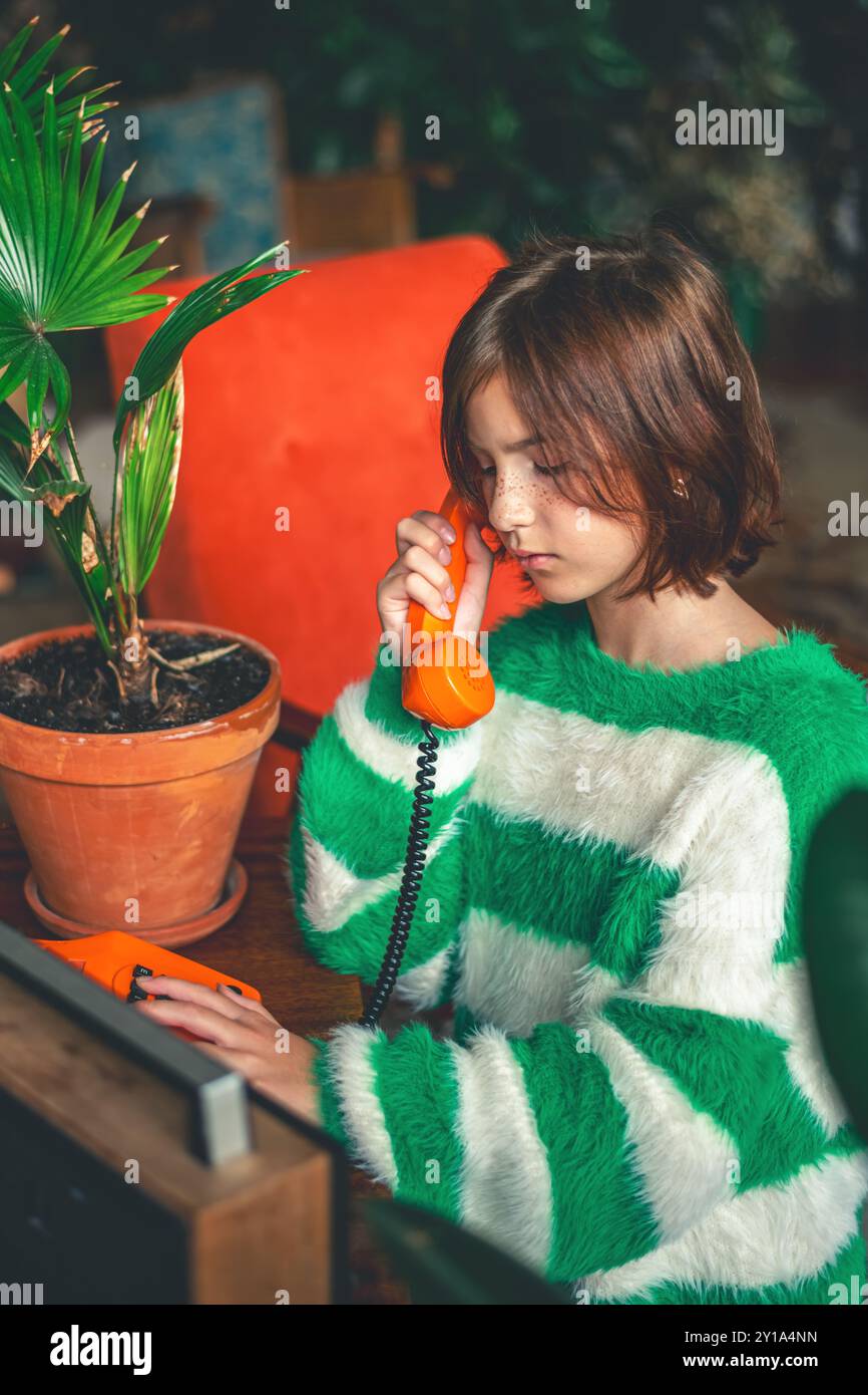 retro, cute girl teen talking on old orange vintage phone with dialer ...