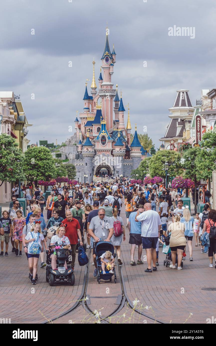 Disneyland Paris, main street with sleeping beauty castle in the ...