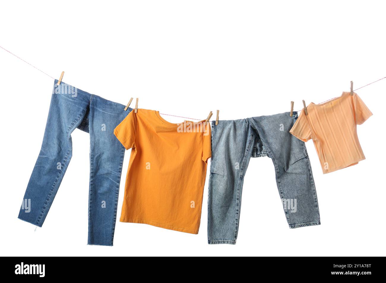 Different clean clothes hanging on rope against white background Stock ...