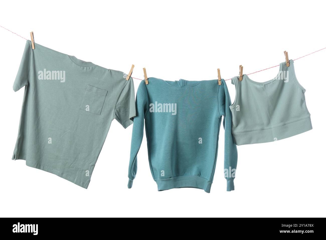 Stylish clean clothes hanging on rope against white background Stock ...