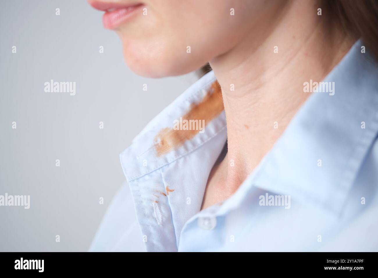 Close-up stained blue shirt collar a neutral background in a well-lit ...