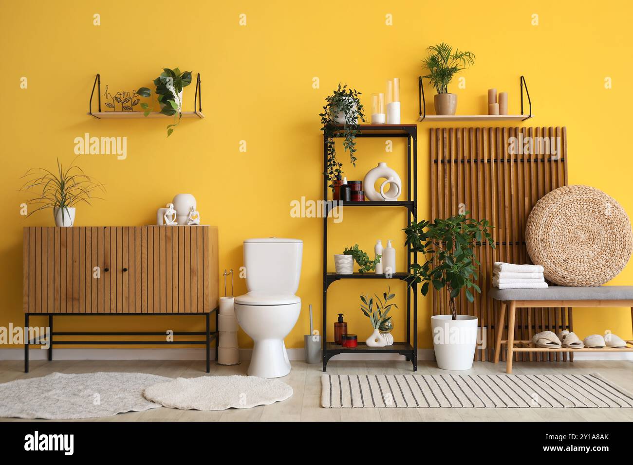 Interior of restroom with toilet bowl, commode and bench Stock Photo ...
