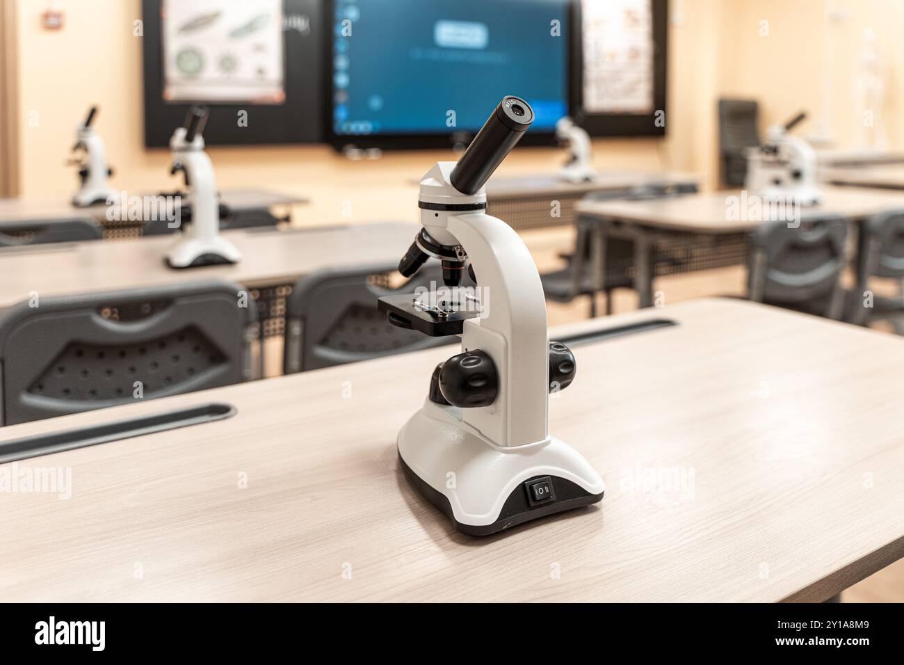 The microscope stands on a desk in the biology or natural science ...