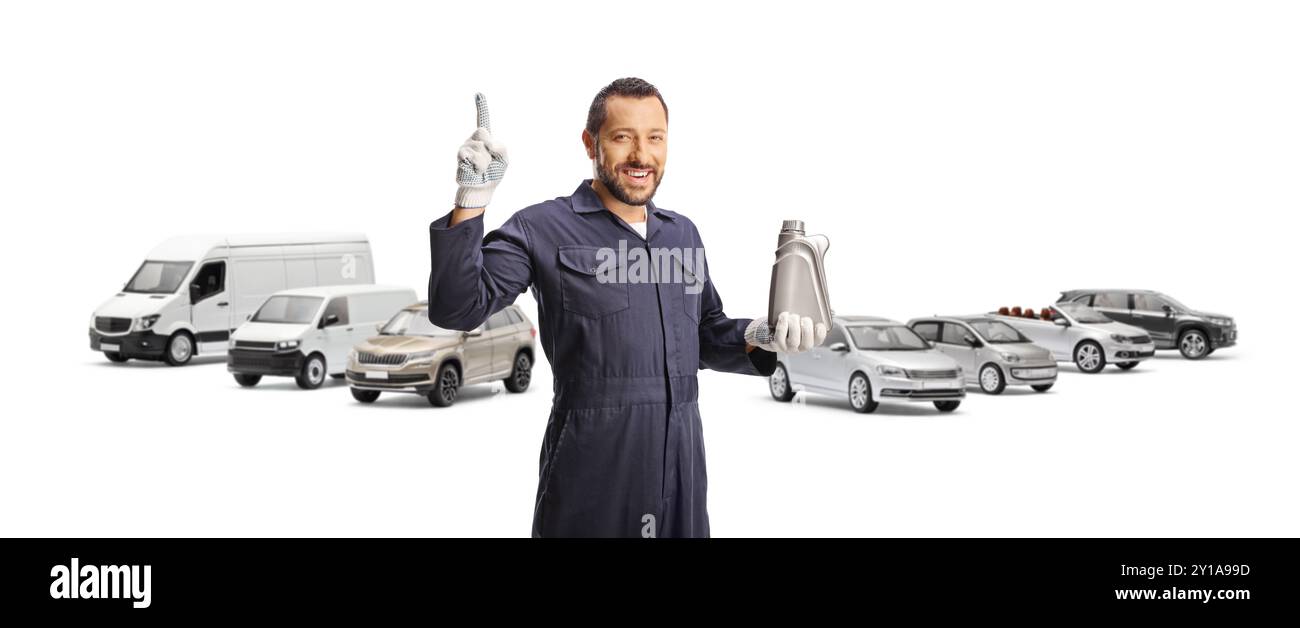 Car mechanic holding an engine oil plastic bottle and pointing up at a ...