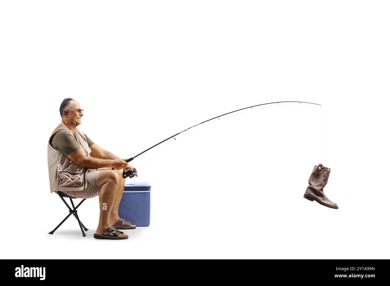 Full length profile shot of a fisherman sitting and catching an old ...
