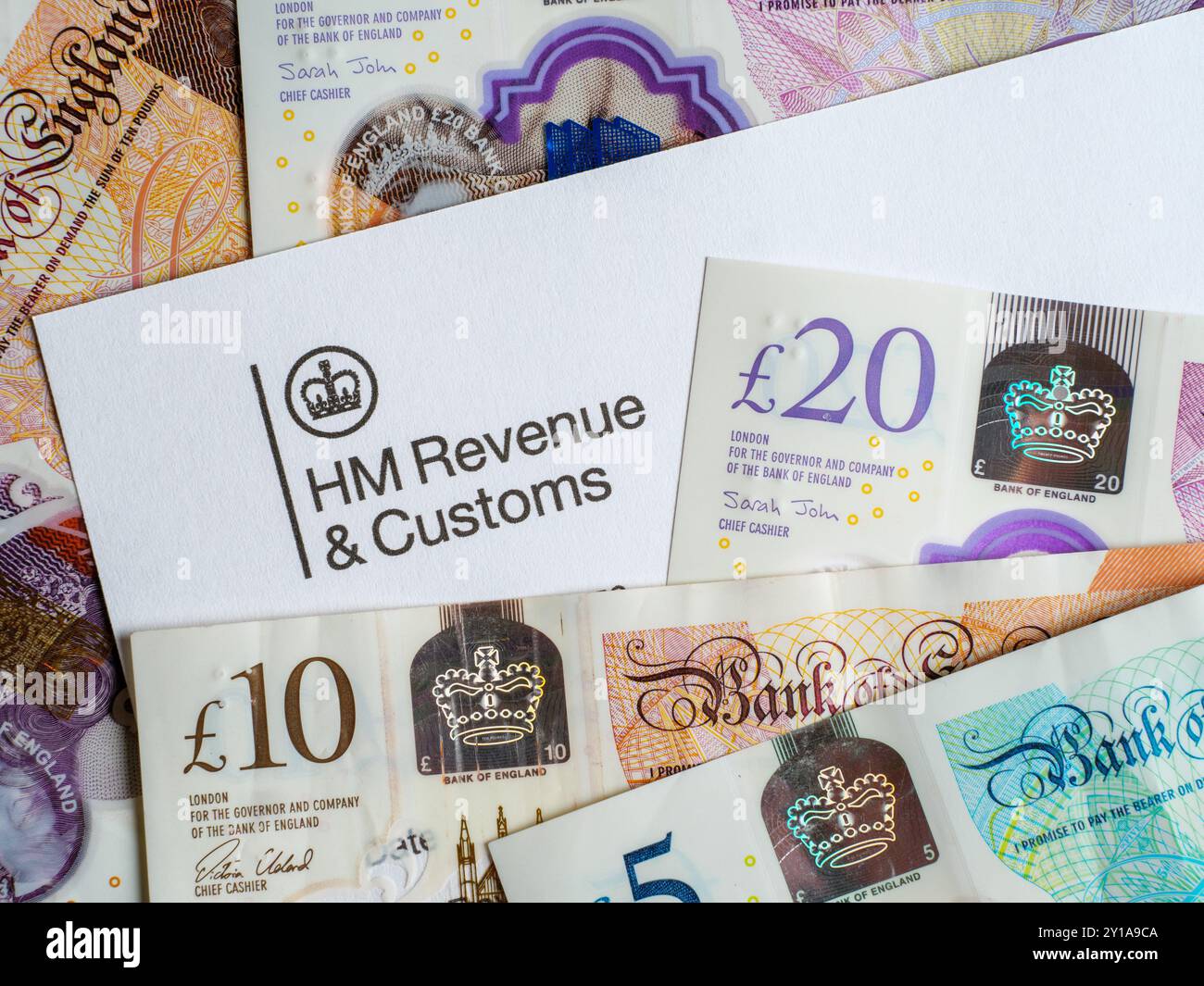 Close up of income tax letter from HM Revenue and Customs among a pile ...