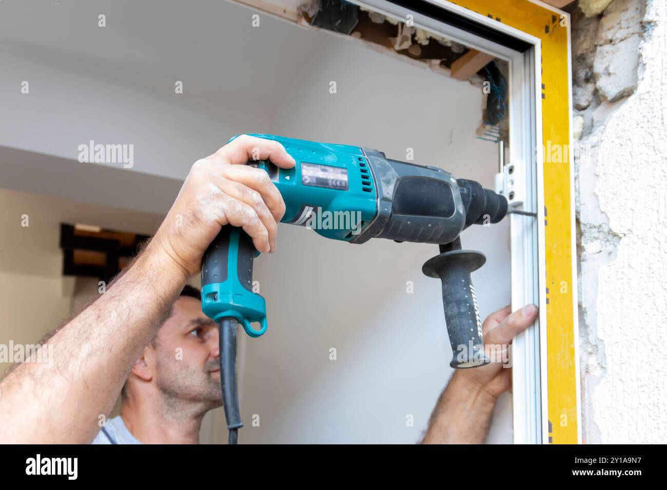 Professional carpenters installing an entrance door in a new apartment ...