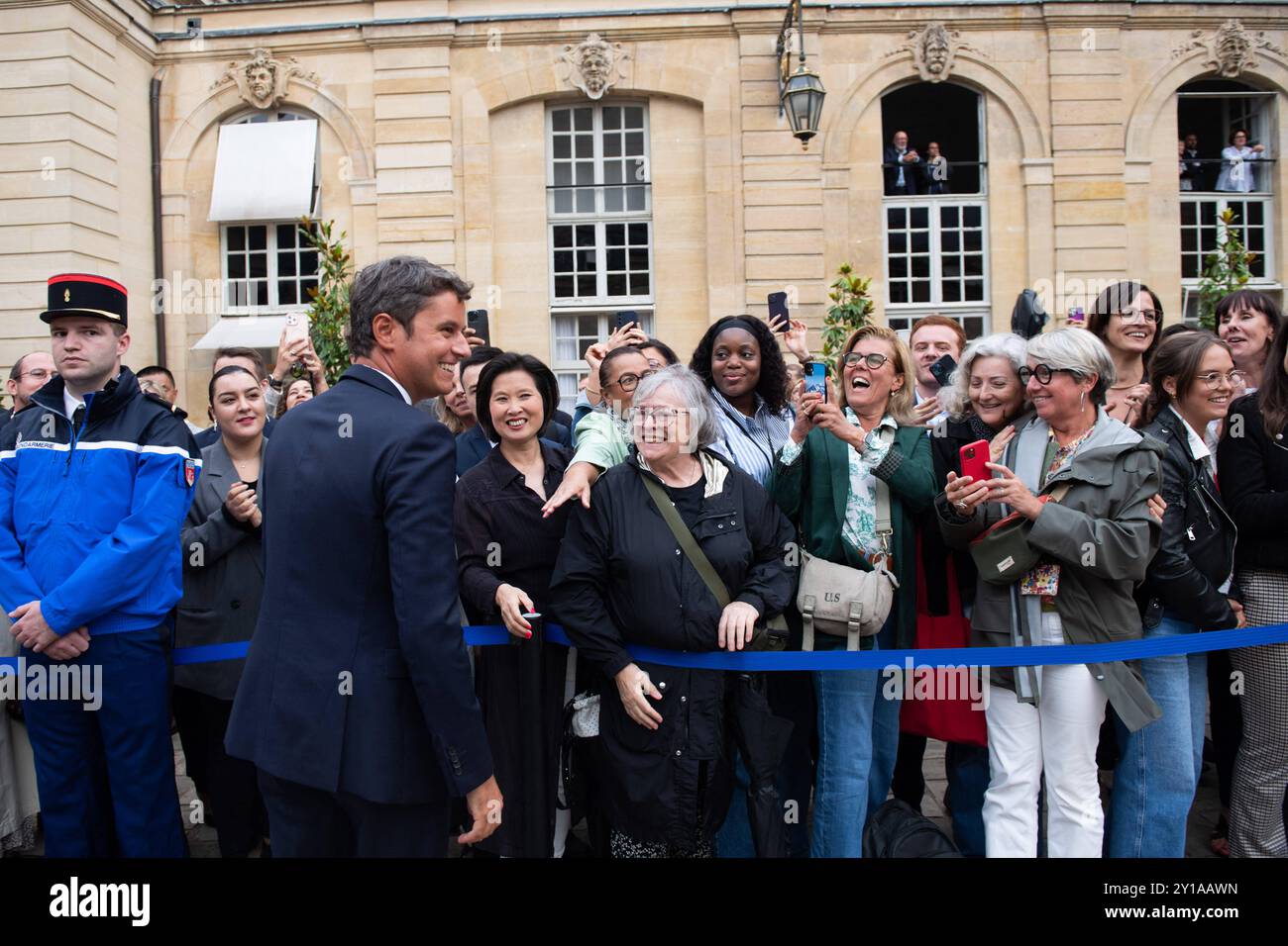 People applauding French outgoing Prime Minister Gabriel Attal during ...