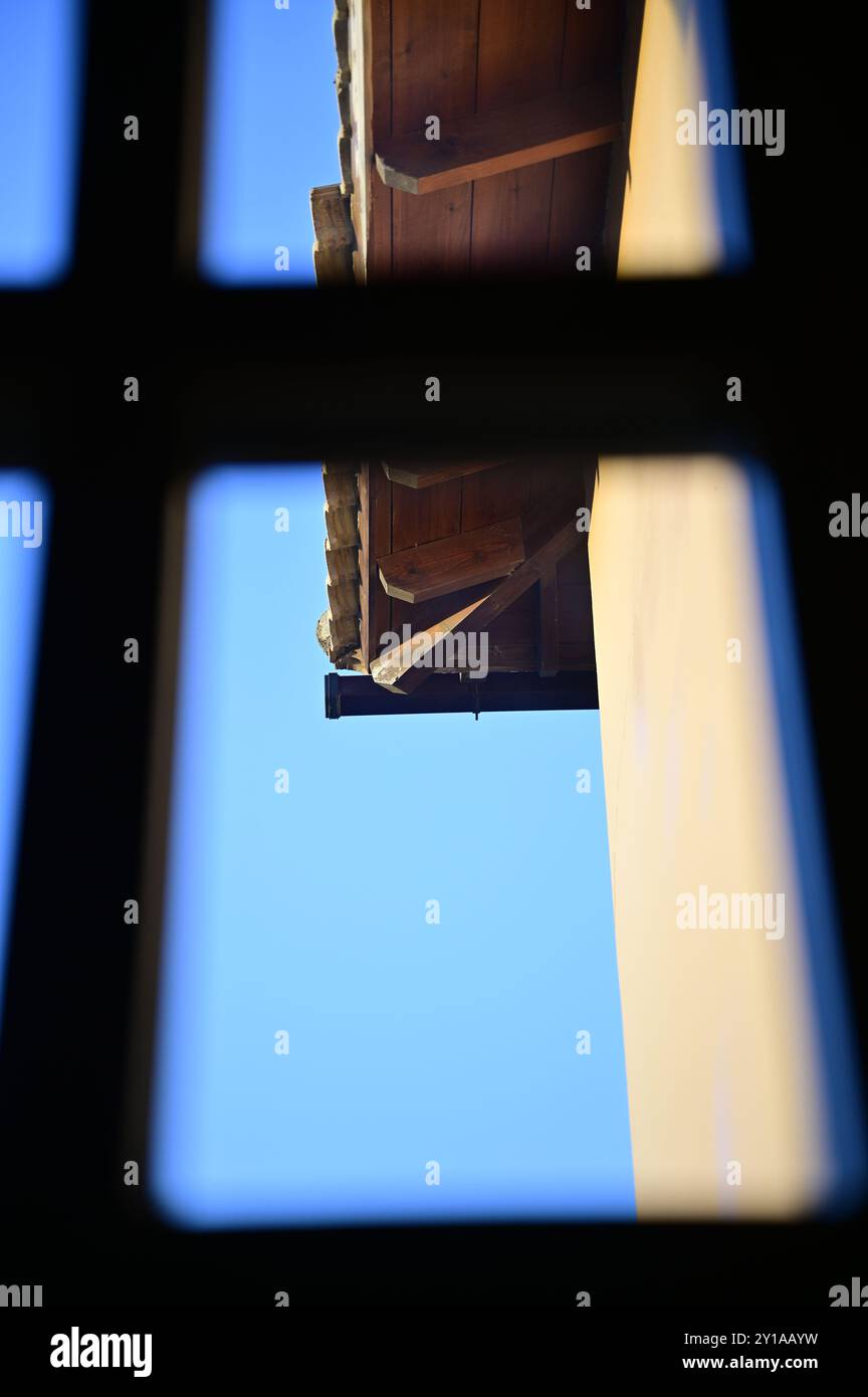 House window looking out at the sky and tiles Stock Photo - Alamy