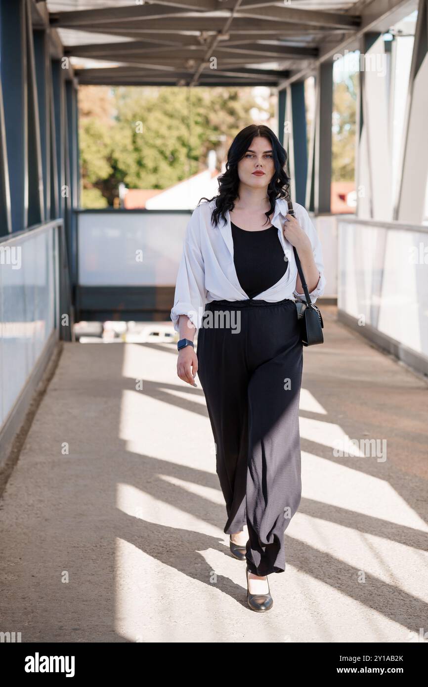 Confident Young Woman Striding in Modern Urban Setting Stock Photo - Alamy