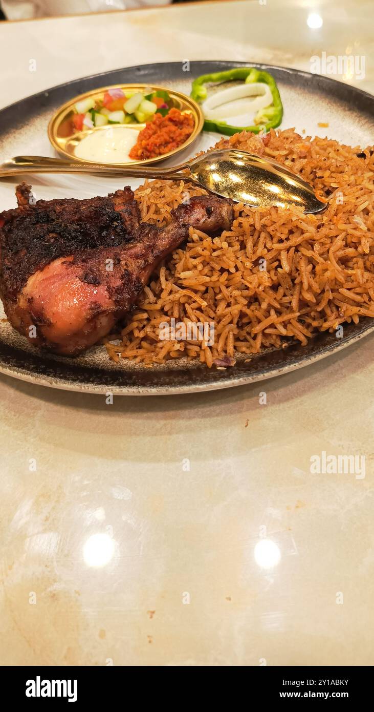 portrait of nasi kebuli ayam (chicken kebuli rice) in the middle with ...