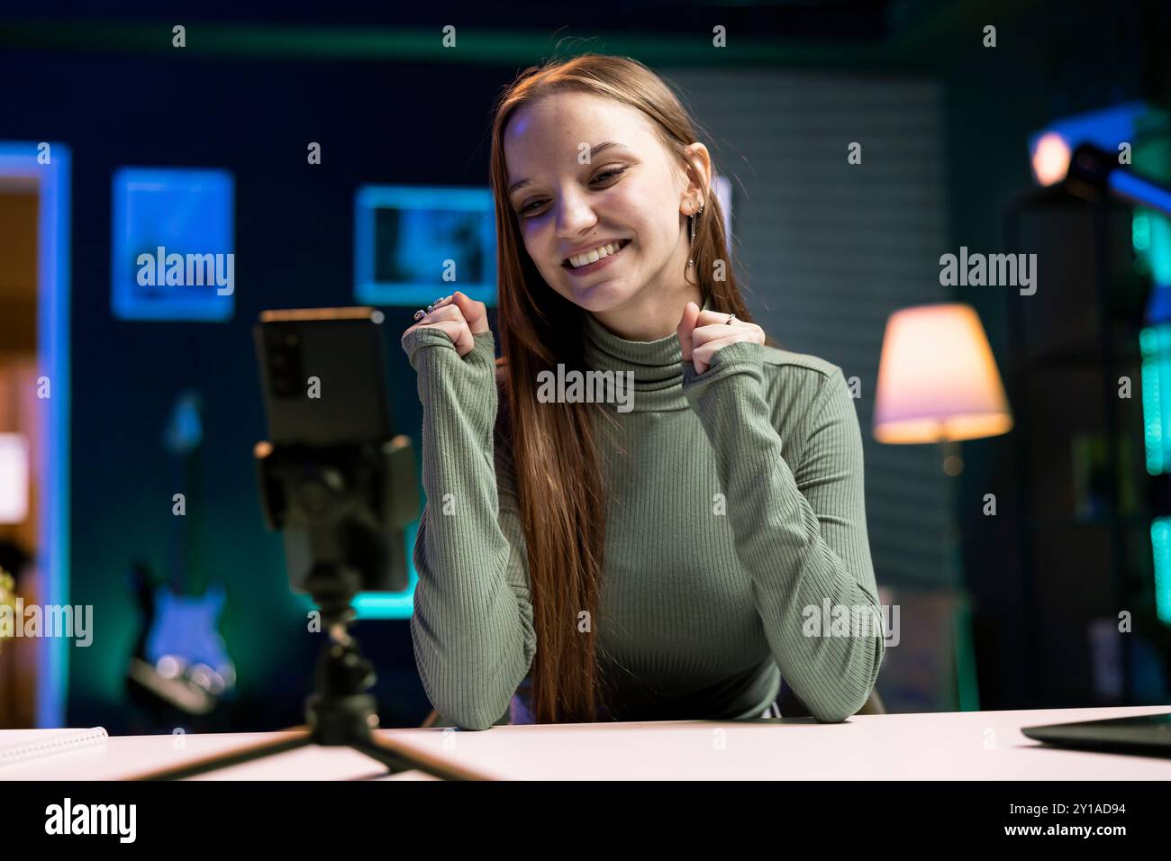 Happy content creator records introductory video with smartphone ...