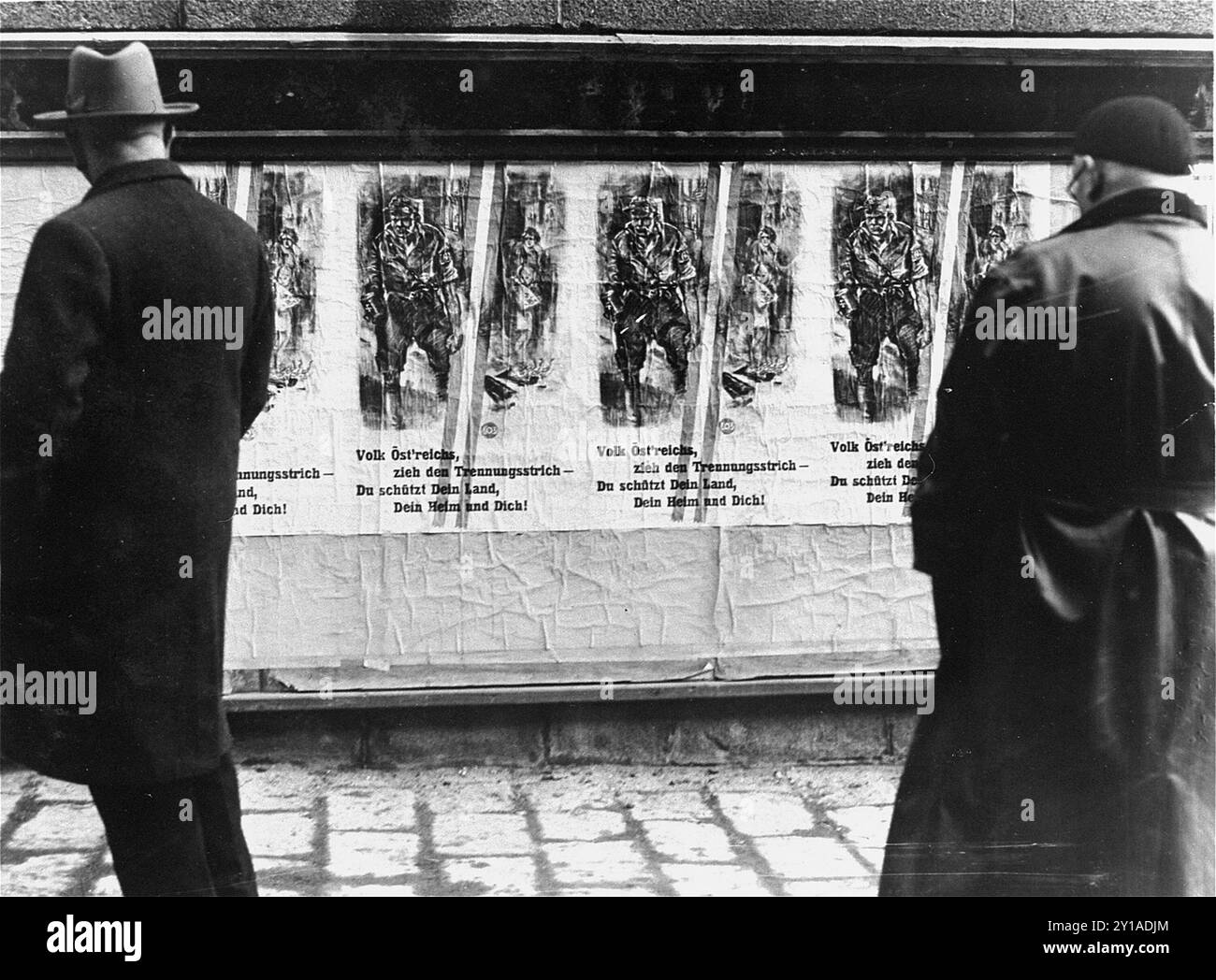 Viennese pedestrians read an anti-Nazi poster posted by the Ministry of ...