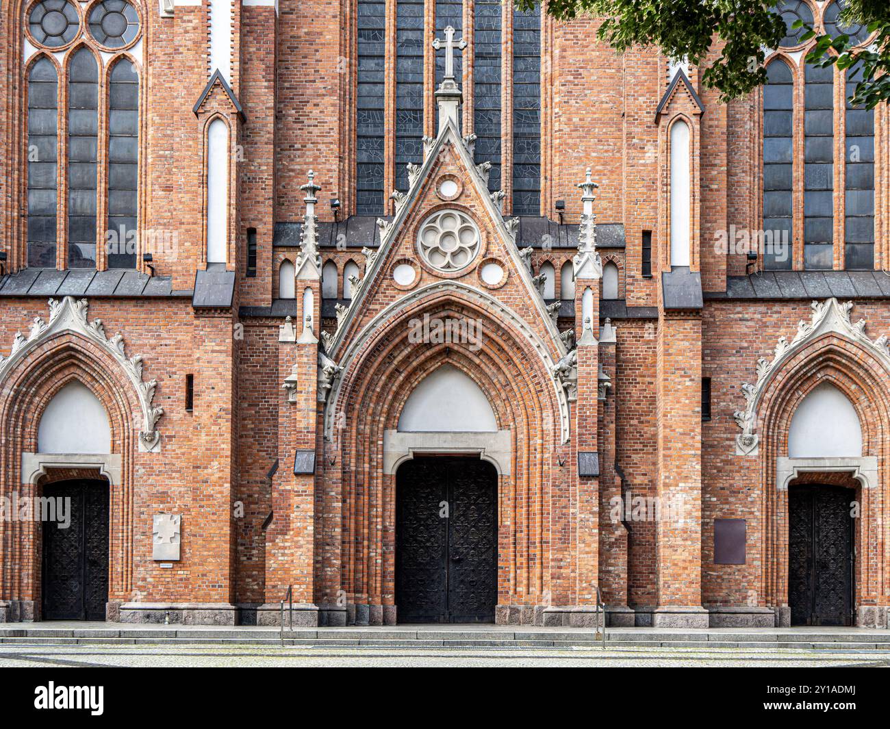 The facade of an old, red-brick, neo-Gothic church Stock Photo - Alamy