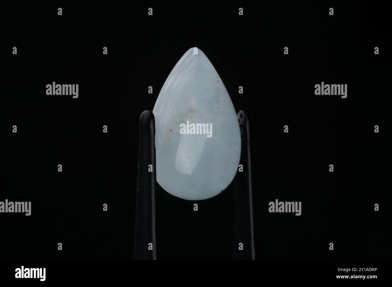 Elegant Teardrop-Shaped Milky White Gemstone Displayed on Dark ...