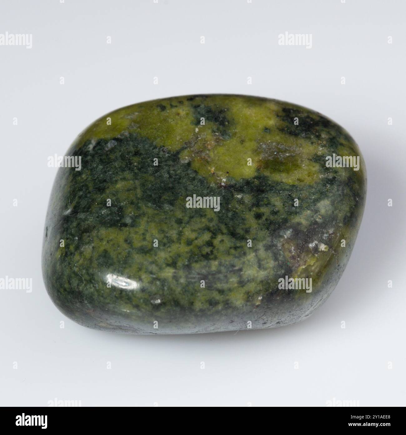 Vibrant Green Serpentine Gemstone Against a Soft White Background Stock ...