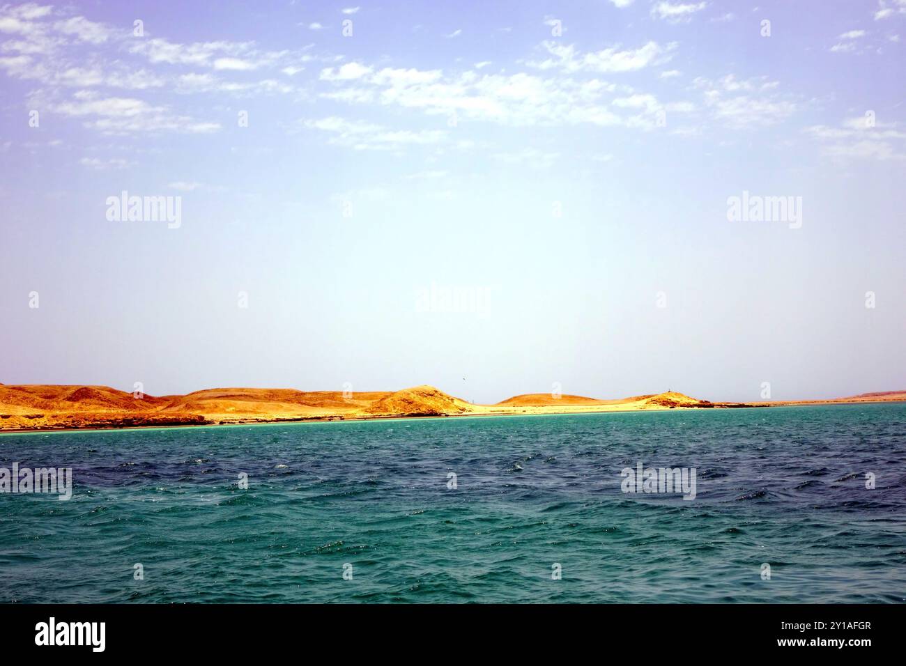 The clear waters of the sea gently lap against the shores of Hurghada, revealing a picturesque ...