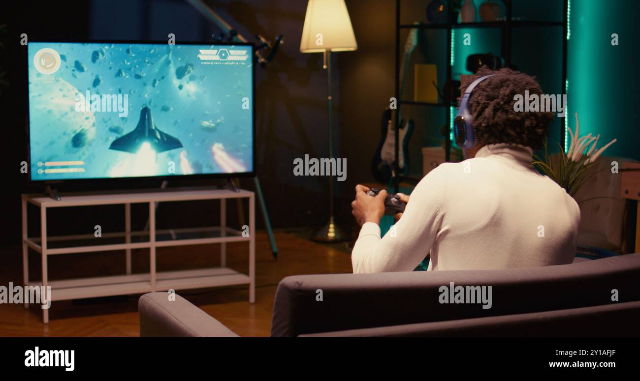 BIPOC man plays SF game with overlay HUD showing health bars and ...