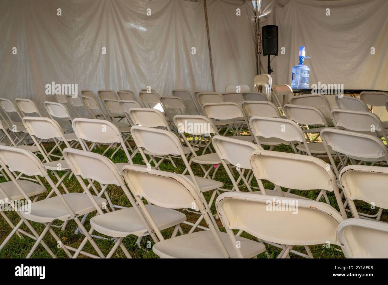 outdoor lecture room under a tent with metal folding chairs Stock Photo ...
