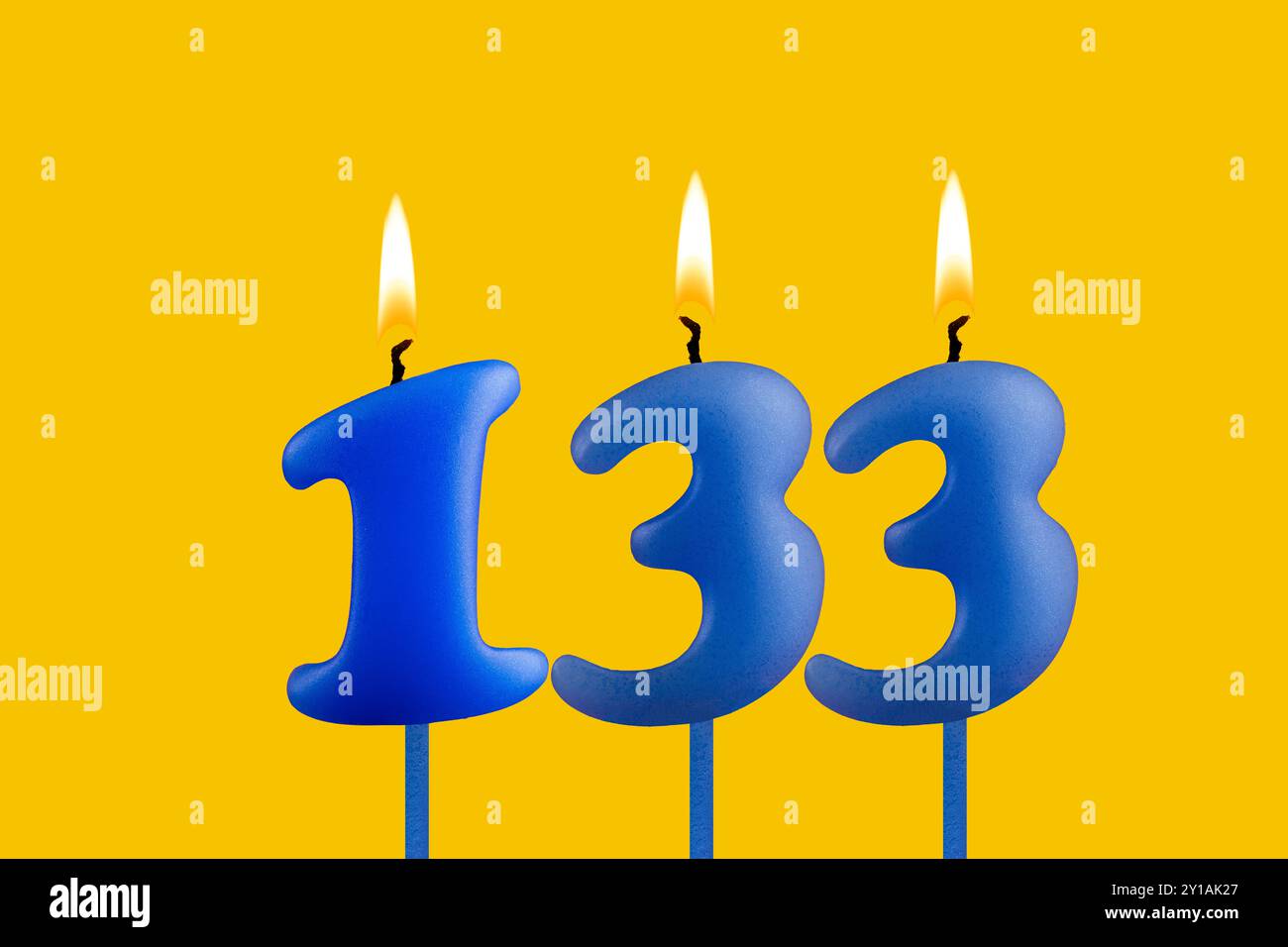 Blue birthday candle on yellow background - Number 133 Stock Photo - Alamy