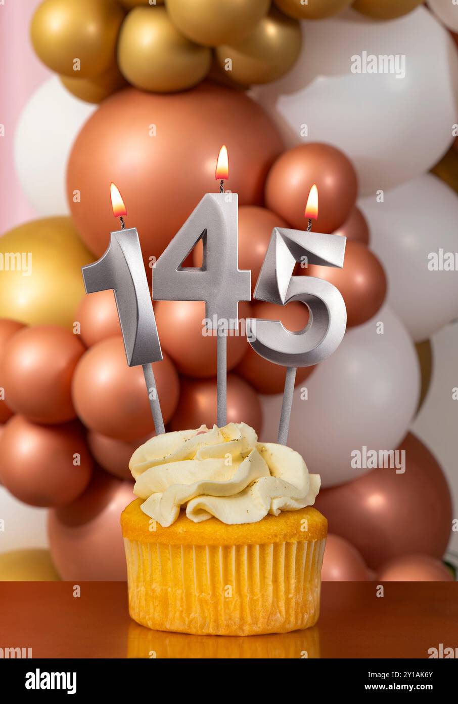 Cupcake with birthday candle on balloons background - Number 145 Stock ...