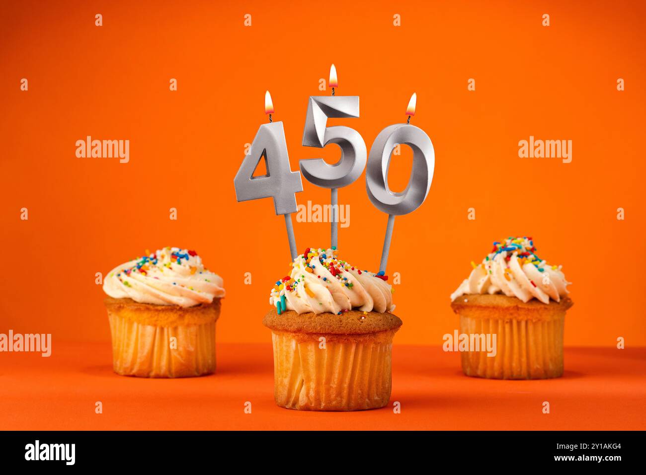 Birthday celebration in orange color - Candle number 450 Stock Photo ...