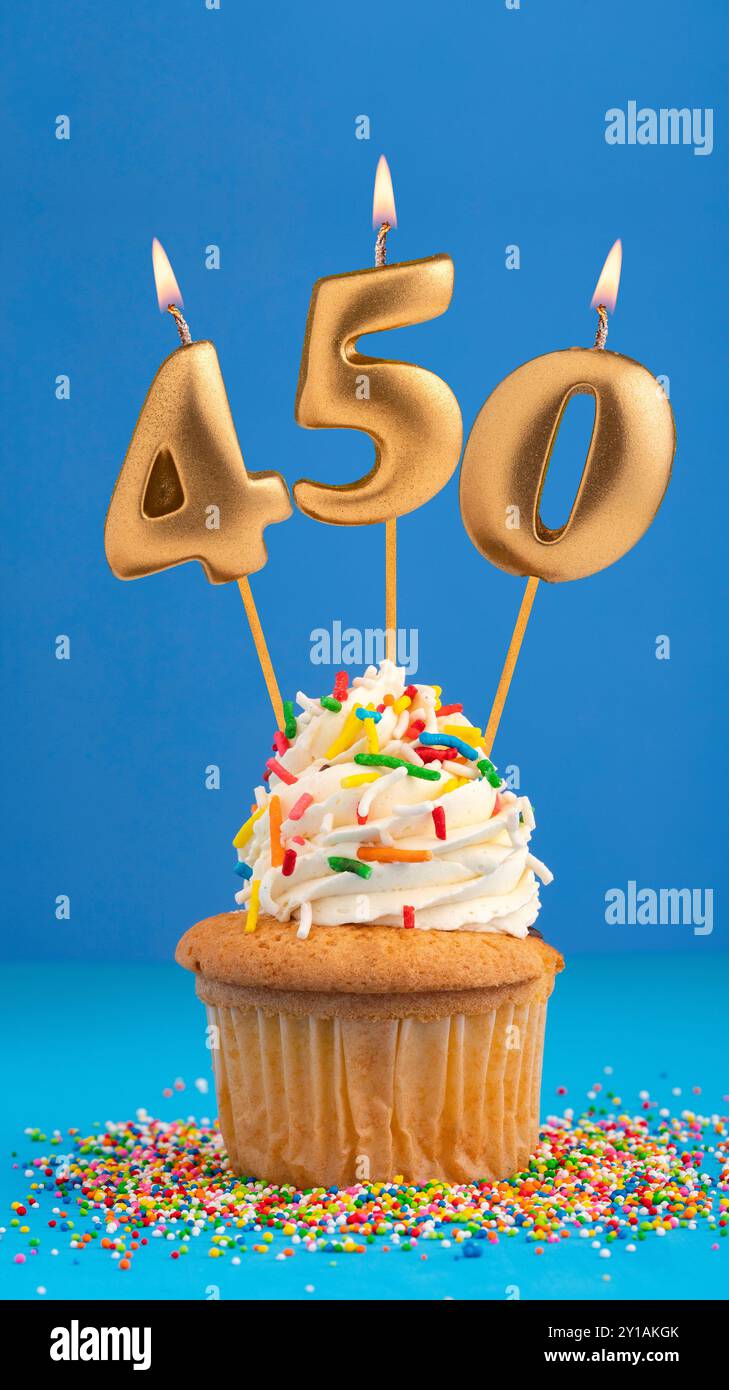 Birthday cupcake with candle number 450 - Blue background Stock Photo ...