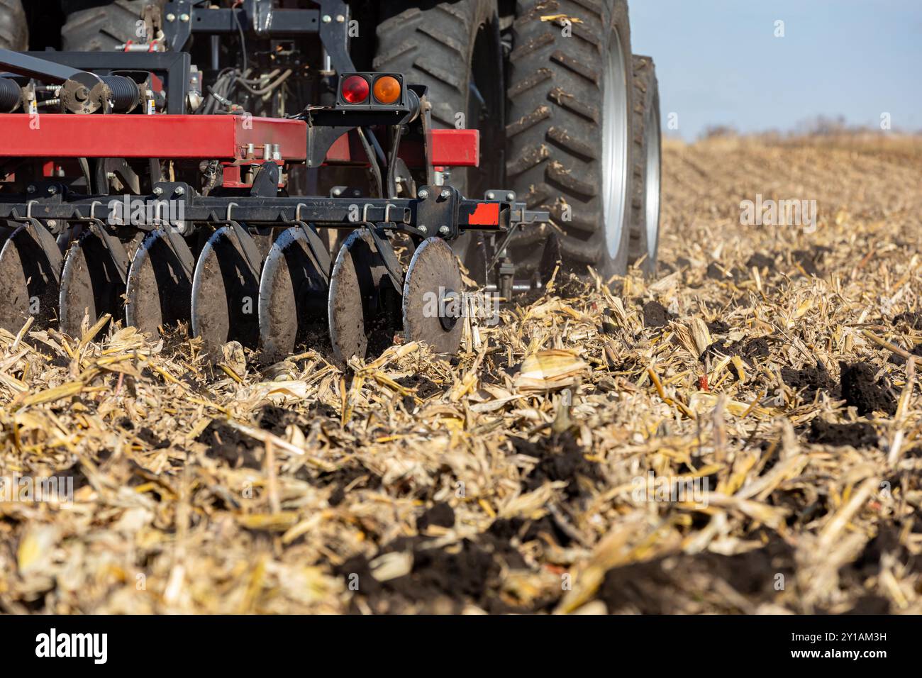 Tractor pulling chisel plow implement in farm field. Farm tillage ...