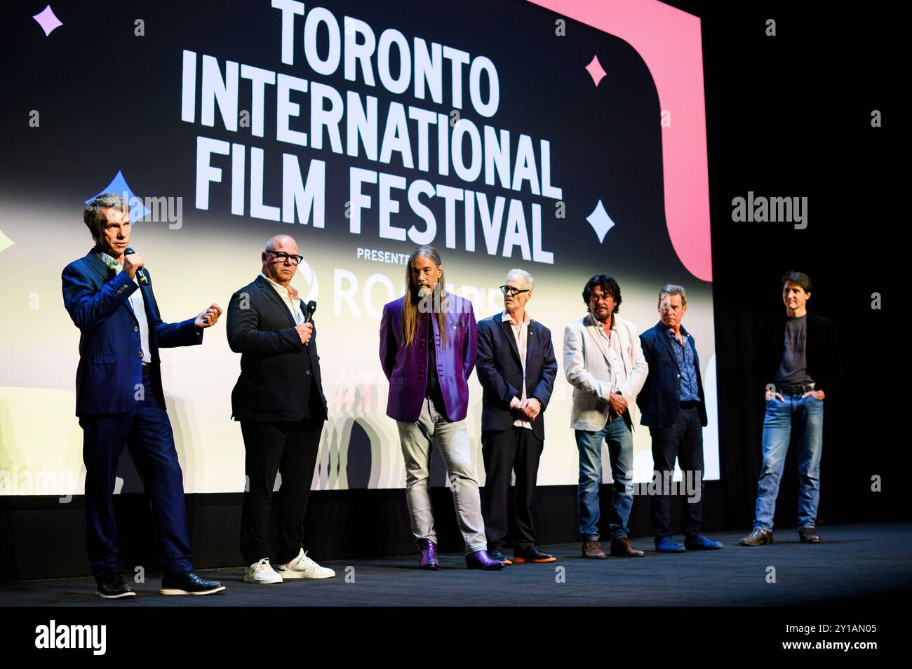 Canada Prime Minister Justin Trudeau, right, stands on stage while ...