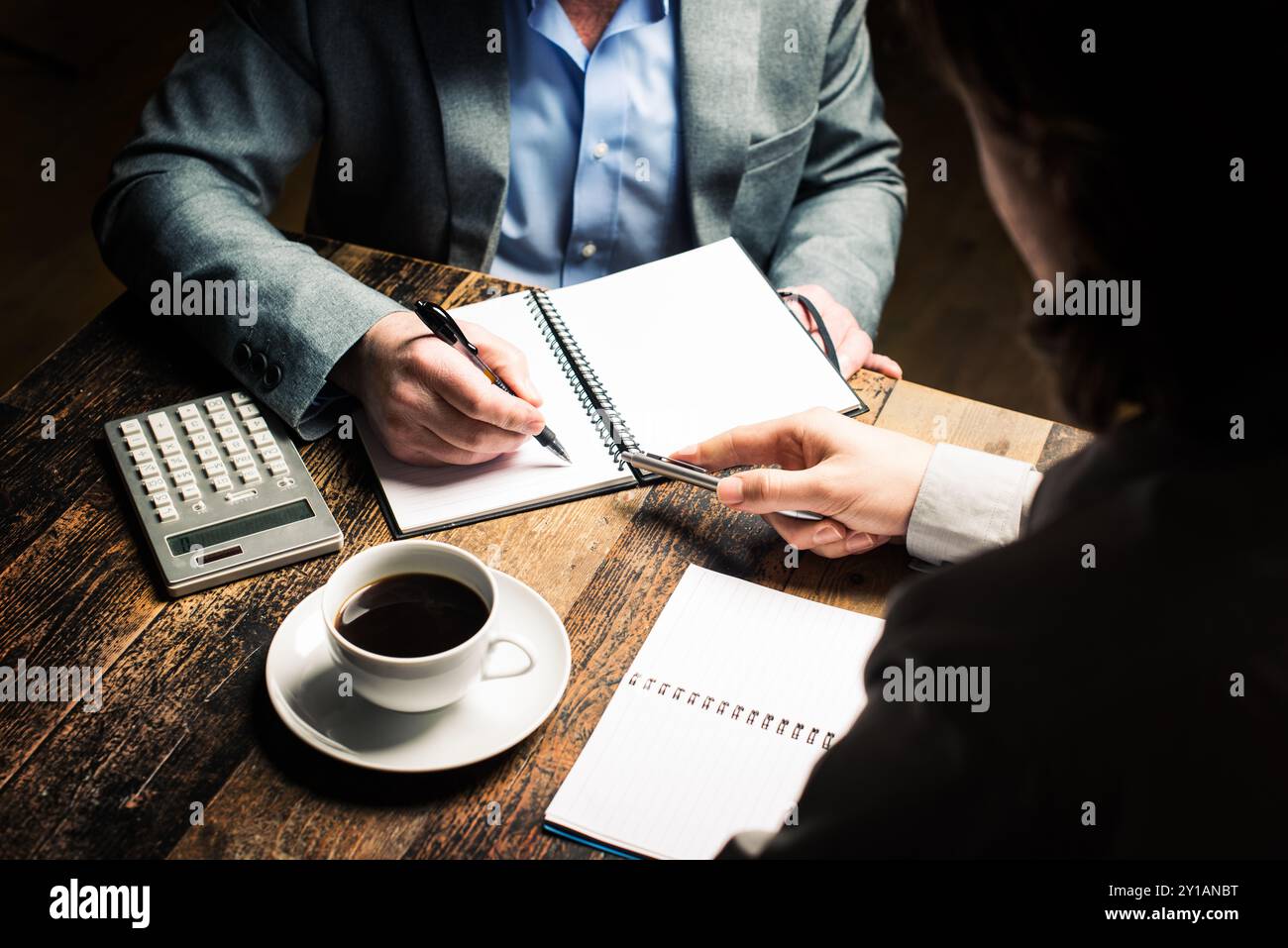 Coffee, budget and business people in cafe with notes, calculator and ...