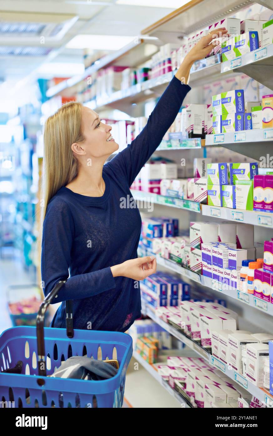 Woman, smile and shopping in pharmacy for medicine, calcium supplements ...