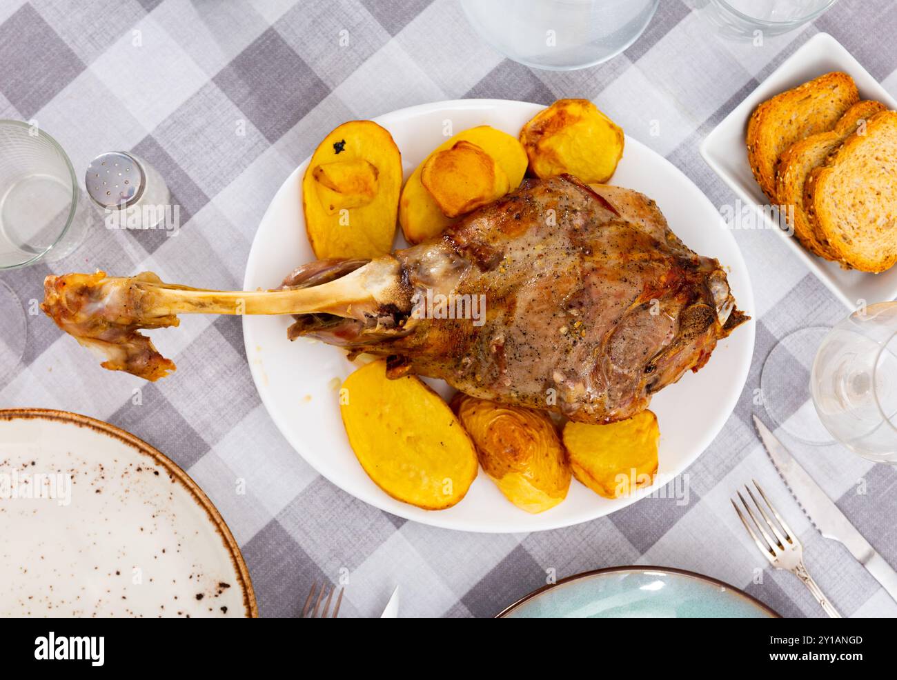 Traditional Spanish lunch is served - fried baked leg of lamb with side ...