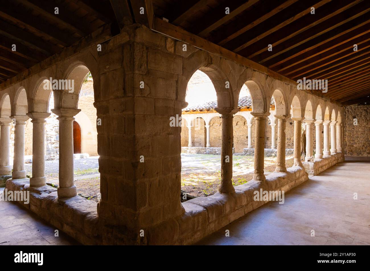 Shaded arched gallery around courtyard at Sant Llorenc de Morunys ...