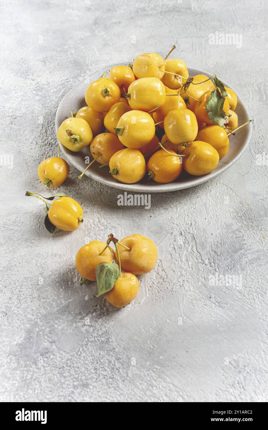 Yellow small apples, Chinese variety, on a gray plate, top view, no ...