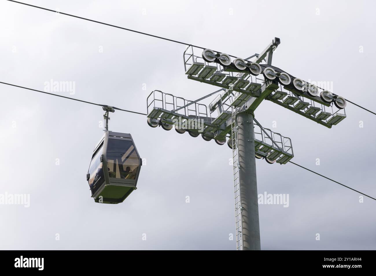 Cable car cabin hanging on a rope in the air, seemingly in motion ...