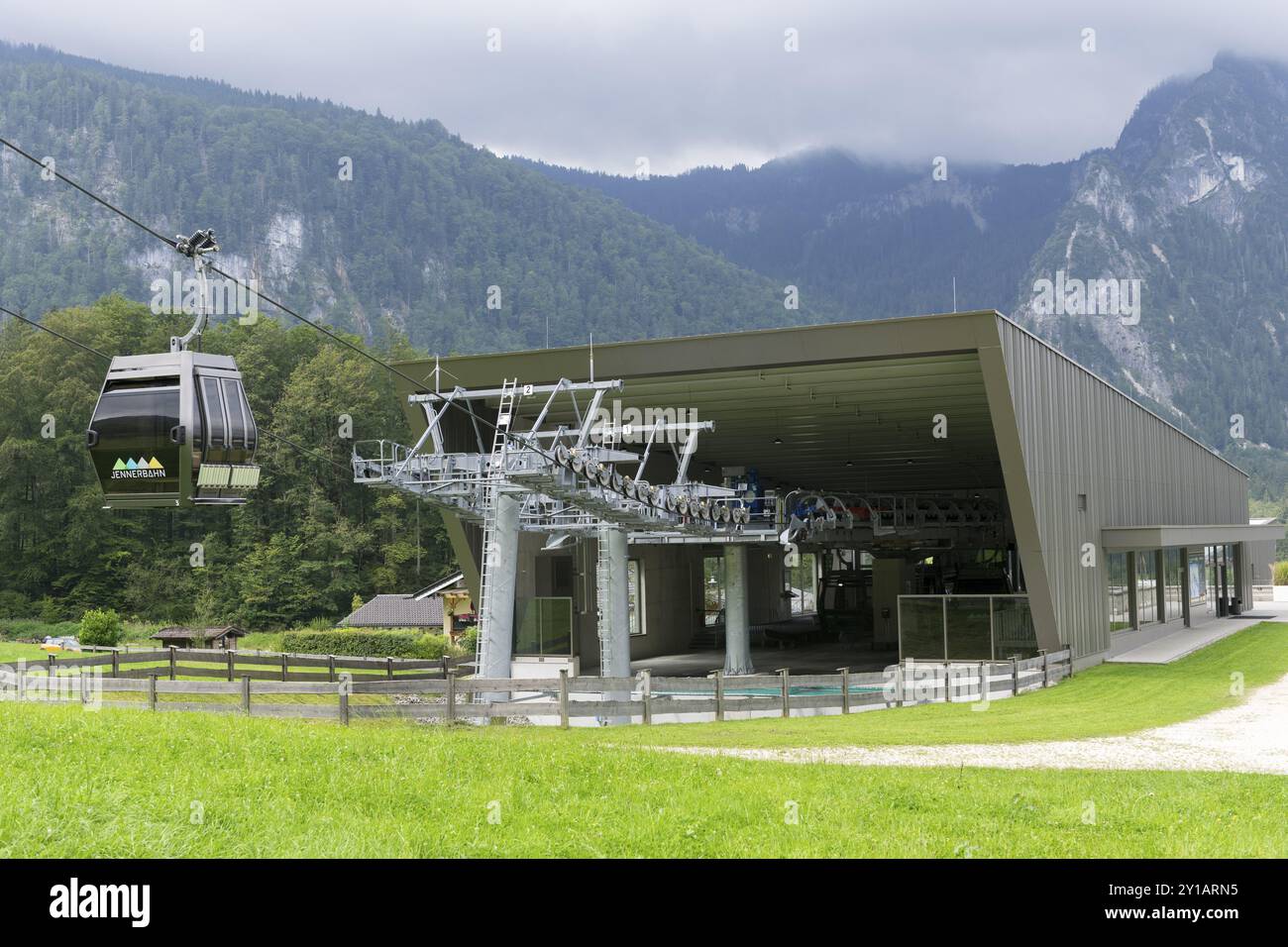 Cable car of the Jennerbahn at the valley station, surrounded by green ...
