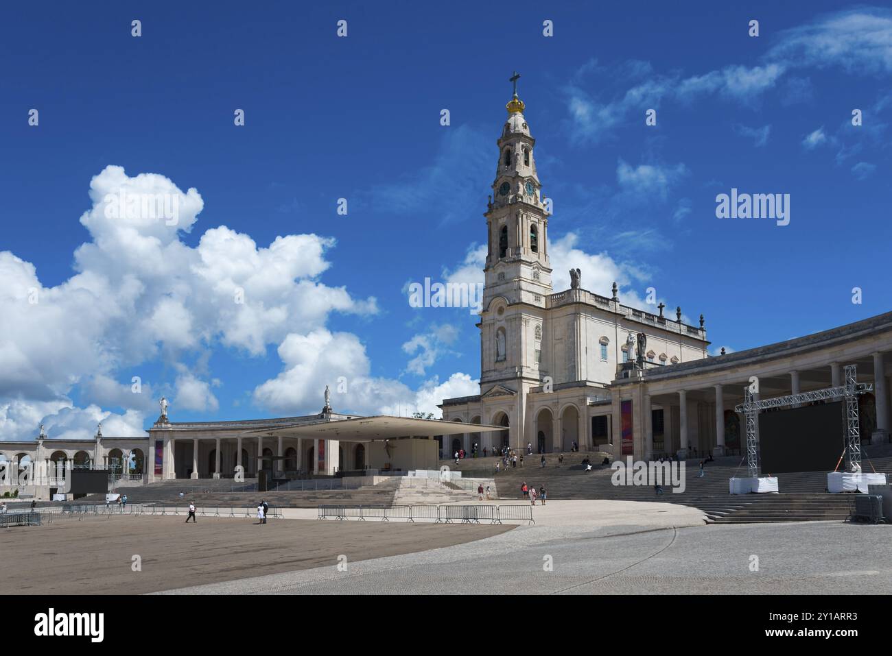 Spacious square with an imposing bell tower and surrounding colonnades ...