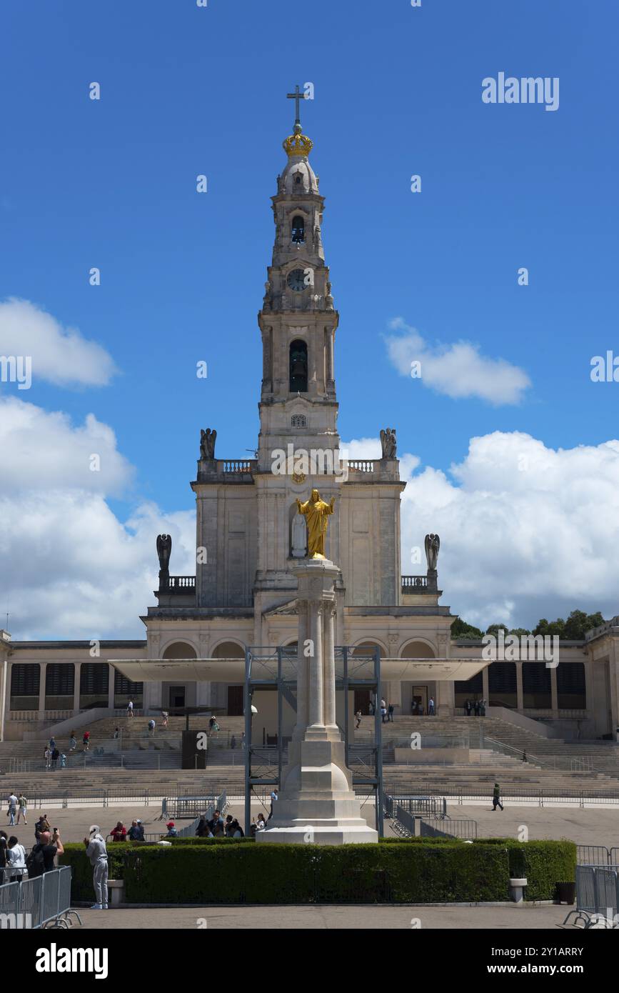 Large basilica with bell tower and statue in the foreground under a ...