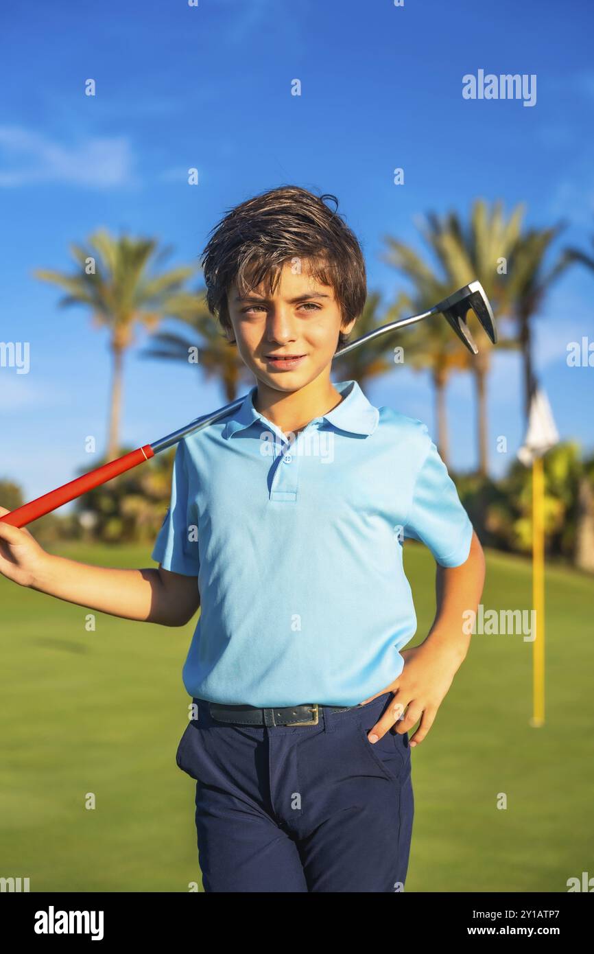 Vertical close-up portrait of a caucasian chic boy posing with gold ...