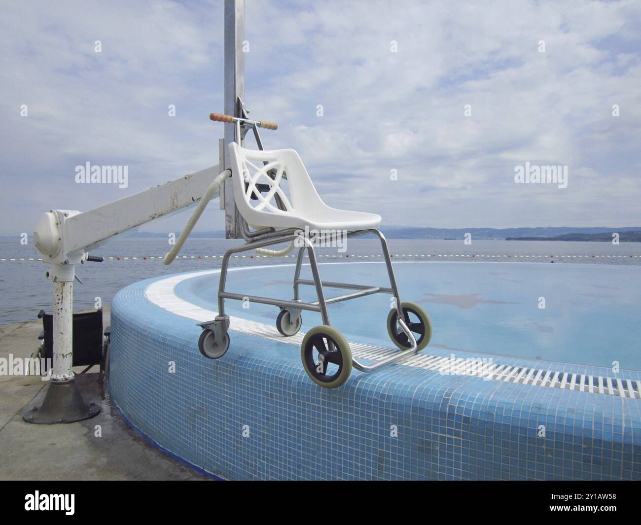 Adapted beach and pool with lift for disabled swimmers Stock Photo - Alamy