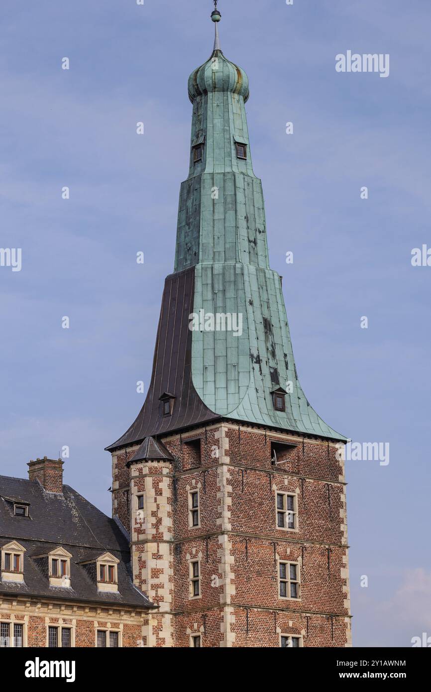 Historic brick tower with green copper roof, surrounded by stone ...